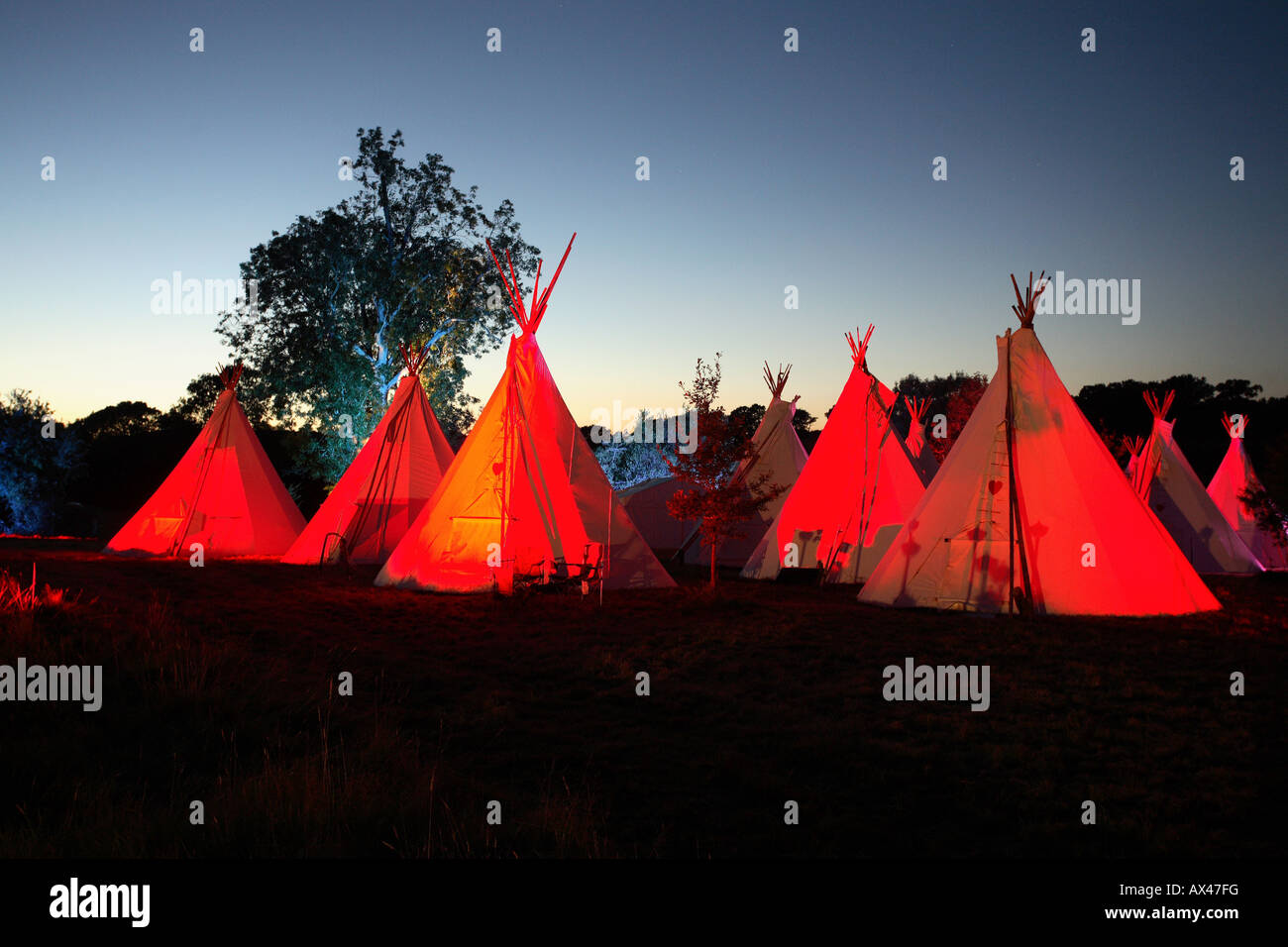 A row of teepees at dusk in an English field Stock Photo - Alamy