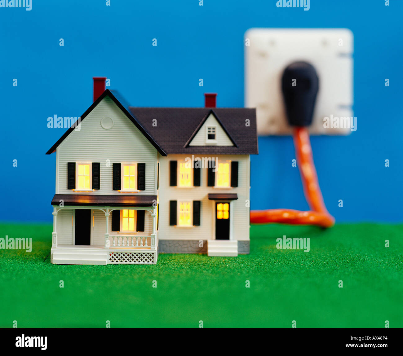 Miniature House Plugged into Electric Socket Stock Photo - Alamy