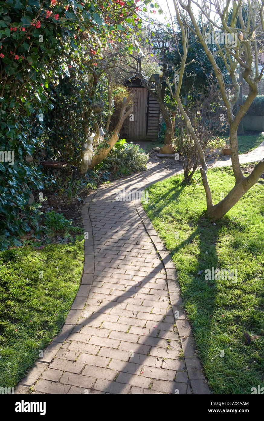 Brick path winding through a garden in the UK Stock Photo - Alamy