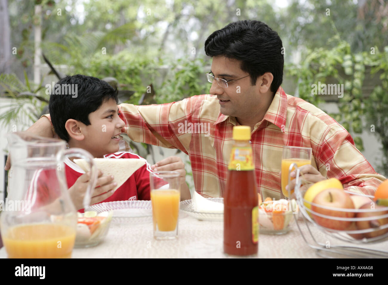 Father eating breakfast with his son at a dining table Stock Photo - Alamy