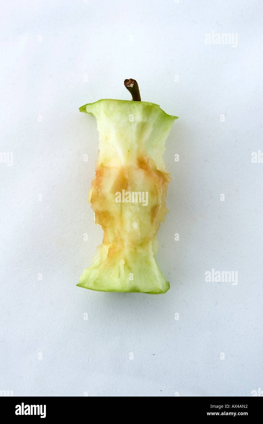 An apple core from a green apple on a grey background Stock Photo - Alamy