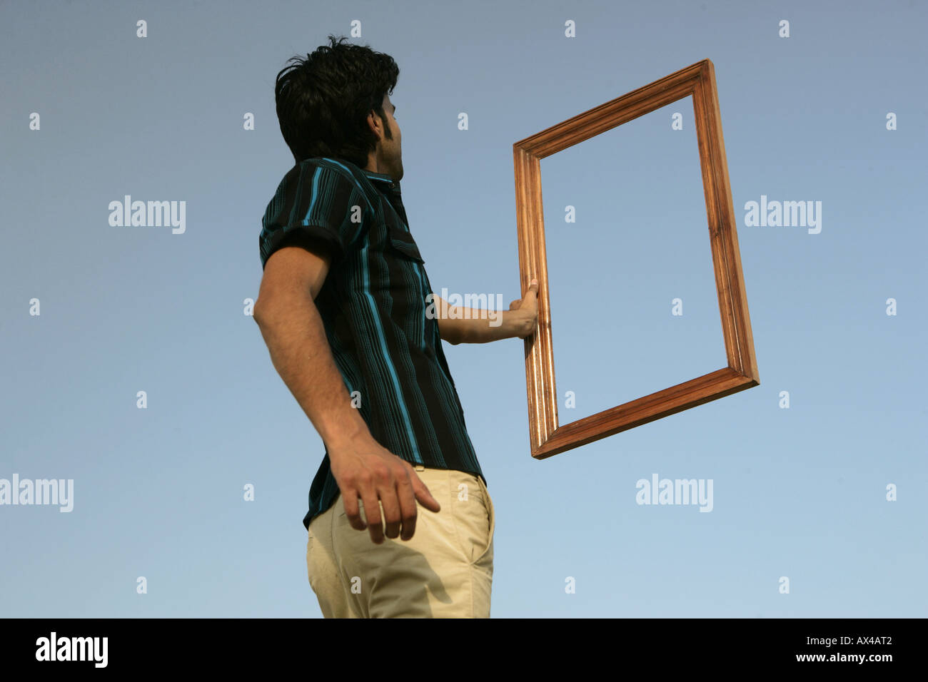 Asian man looking picture frame hi-res stock photography and images - Alamy