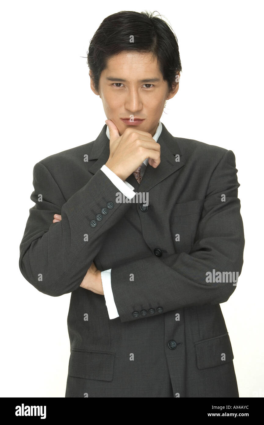 A smart and smooth asian businessman in a grey suit with white shirt ...