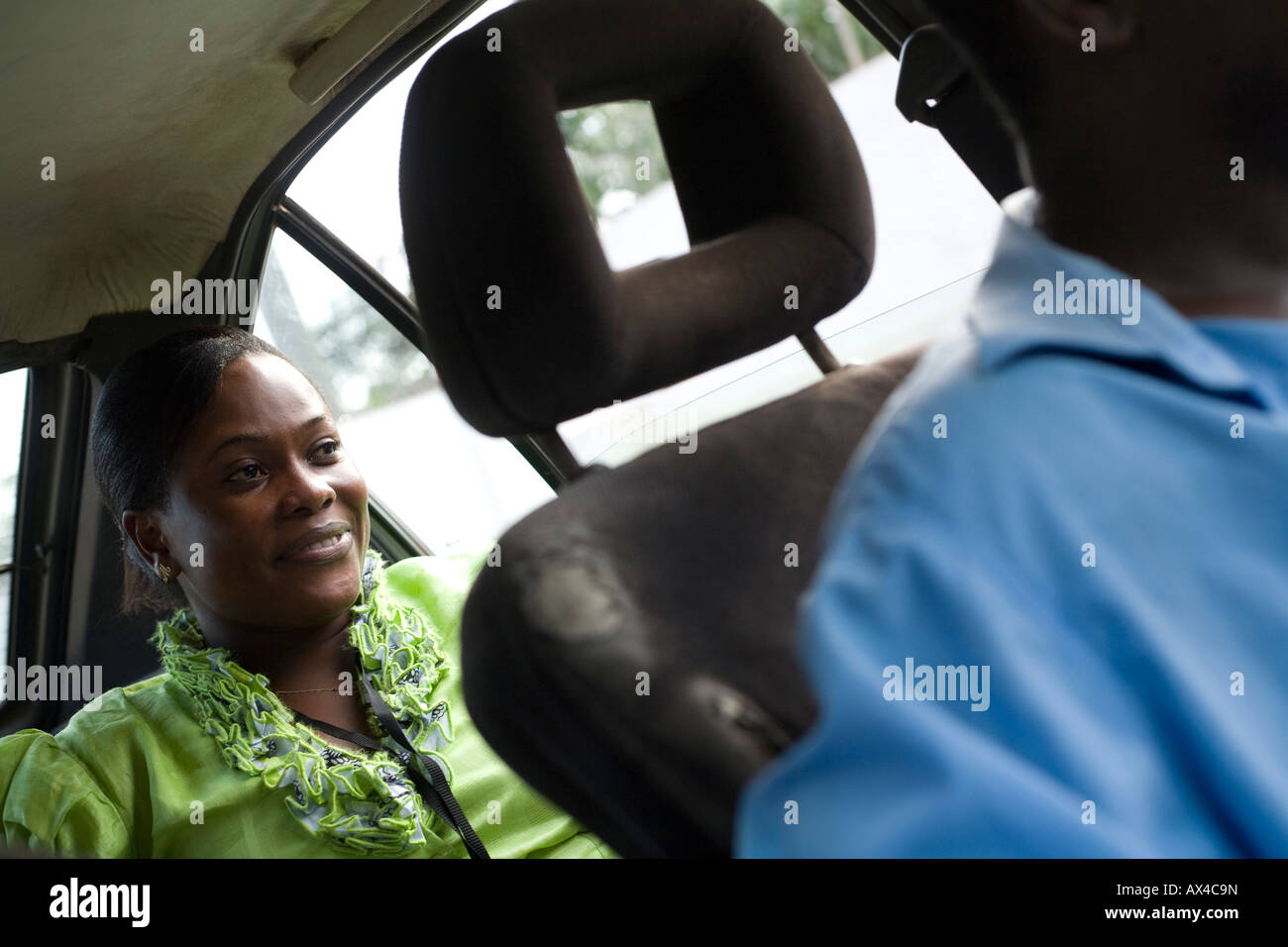 A woman rides in the back of a taxi Stock Photo - Alamy