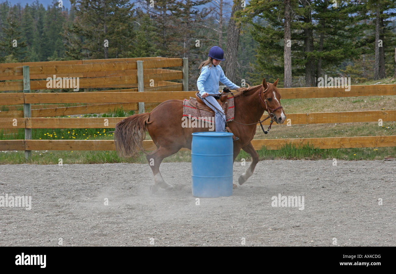 Young girl practising barrel racing Stock Photo - Alamy