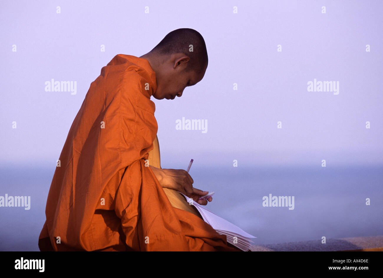 Monk writing on Sisowath Quay Phnom Penh Cambodia Stock Photo - Alamy