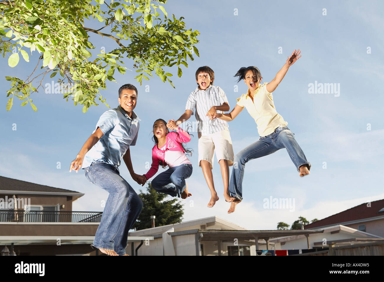 East Asian Family Jumping Hand In Hand High Resolution Stock ...