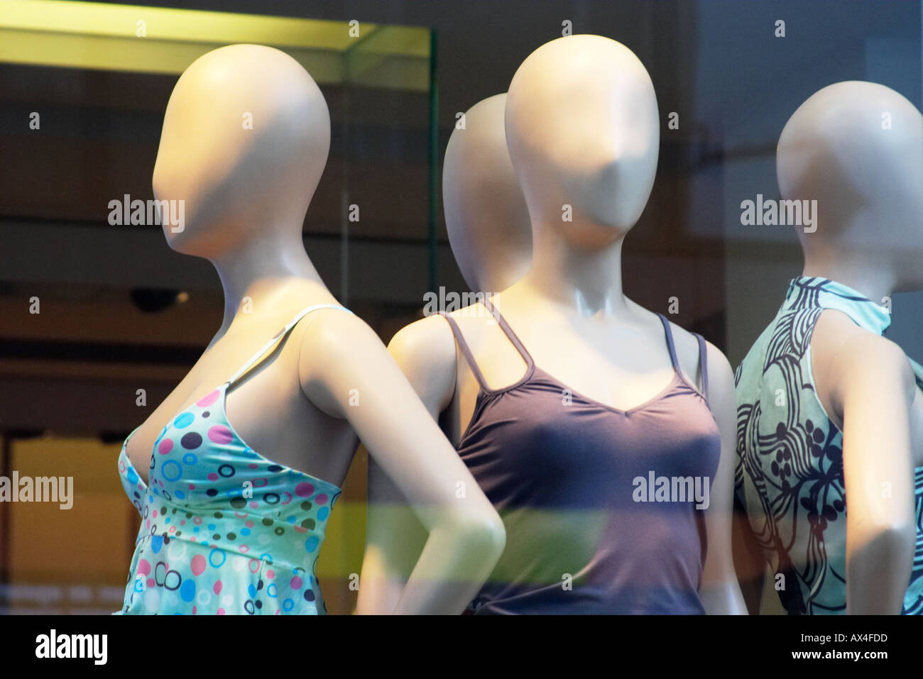 faceless fashion clothing manequins in a shop window in London England ...