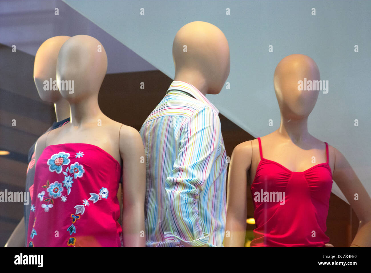 faceless fashion clothing manequins in a shop window in London England ...