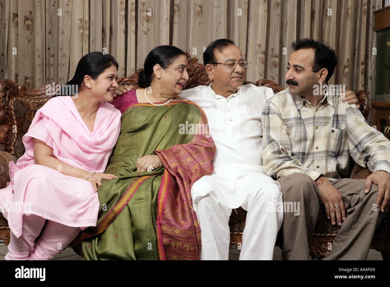 Joint family sitting in a living room Stock Photo - Alamy