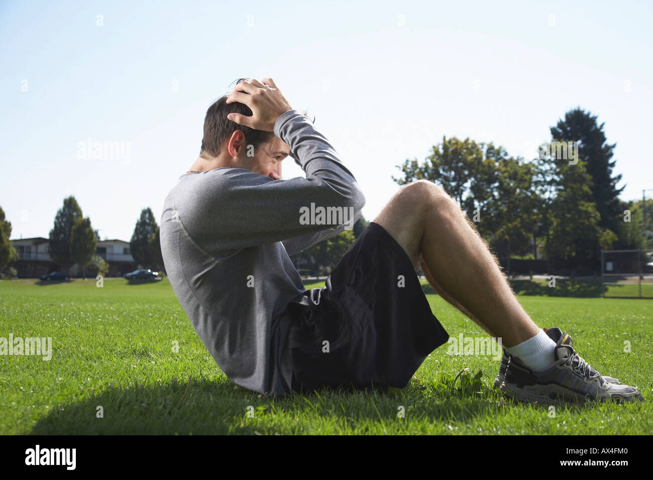 Man Doing Sit-ups Outdoors Stock Photo - Alamy