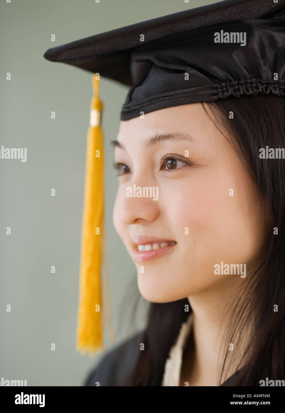 Asian woman wearing graduation cap Stock Photo - Alamy