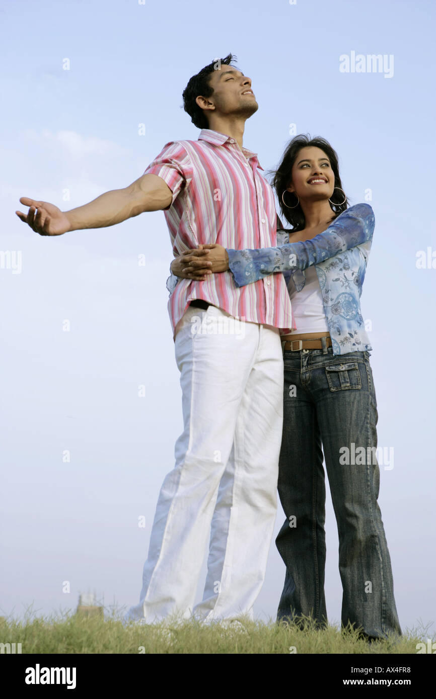 Low angle view of a young couple romancing in a park Stock Photo - Alamy