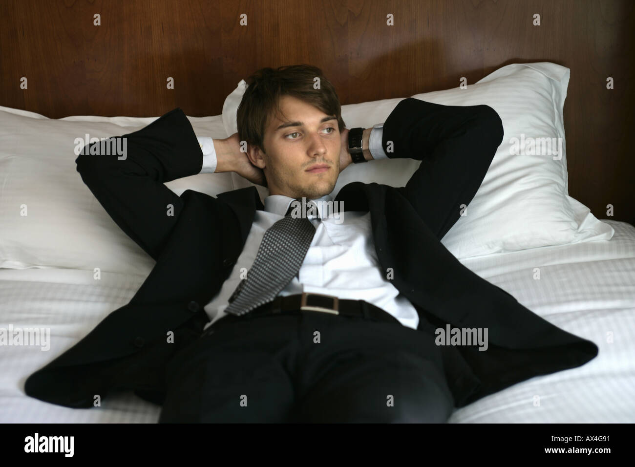 Man in suit lying down Stock Photo - Alamy