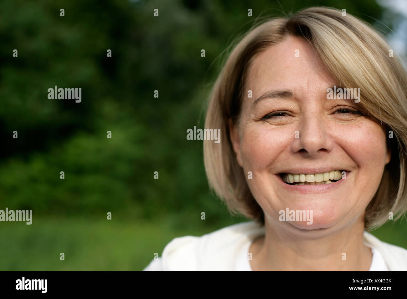 Mature woman smiling at camera, portrait Stock Photo - Alamy