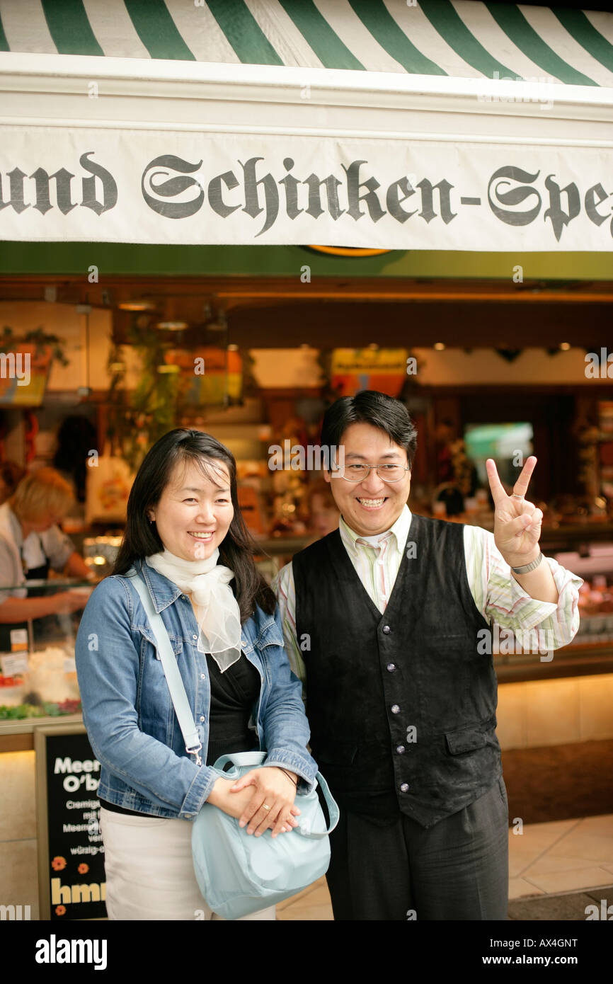 Asian couple standing in front of a shop, selective focus Stock Photo ...
