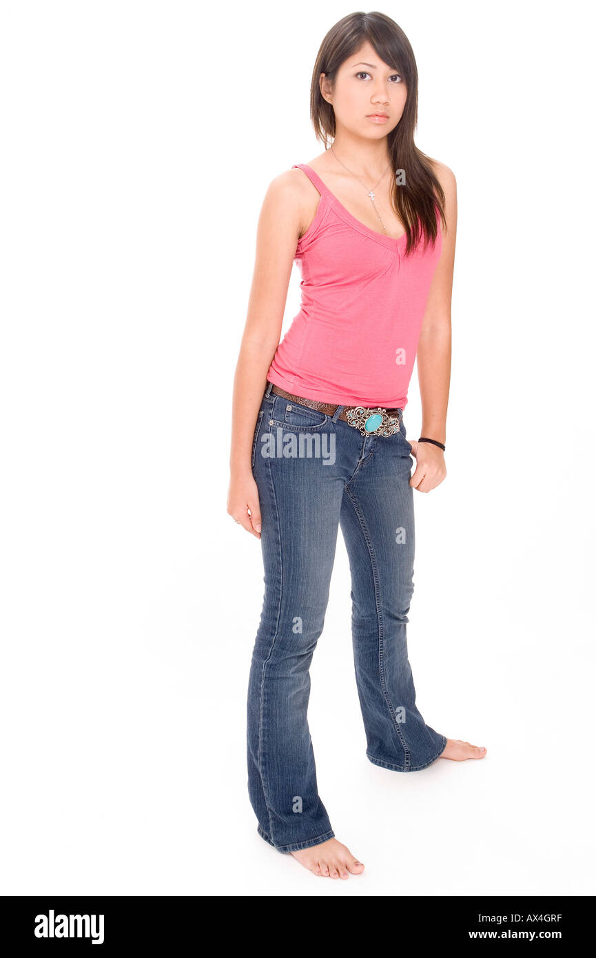 A cute but serious young woman in casual clothes full length pose Stock ...