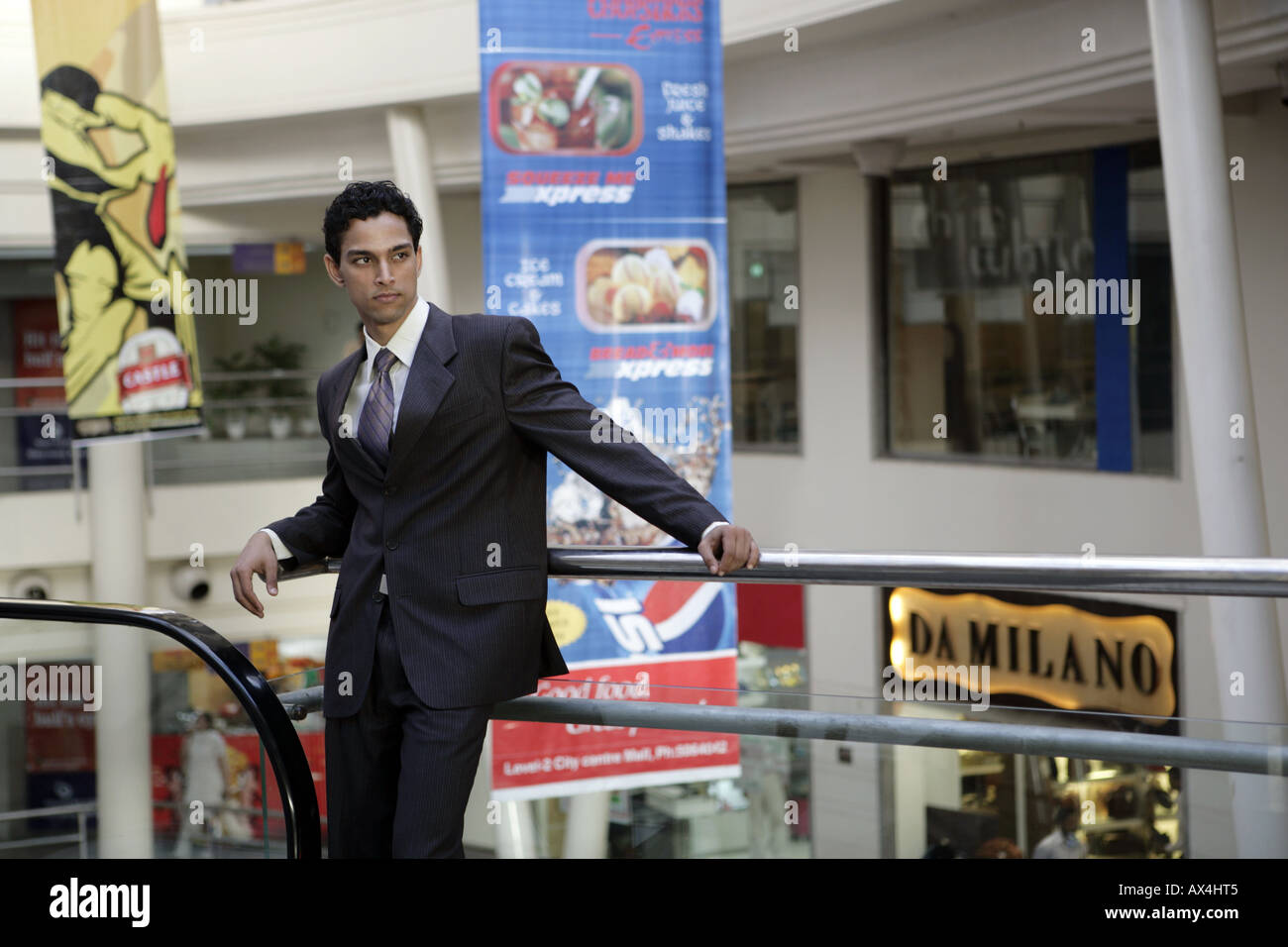 Businessman standing in a shopping mall Stock Photo - Alamy