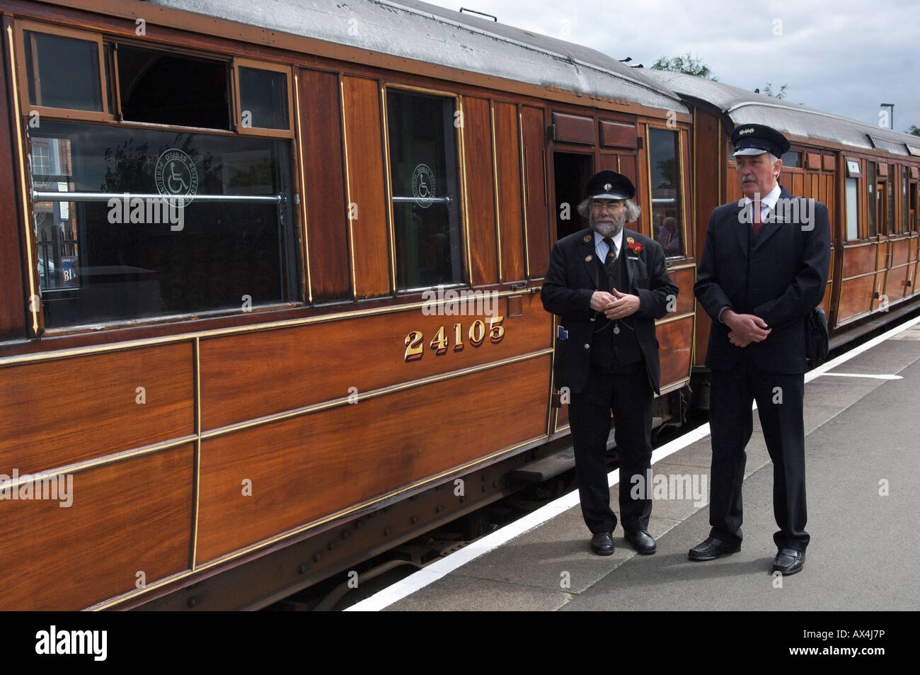 Steam train with carriages and two guards at Kidderminster station on ...