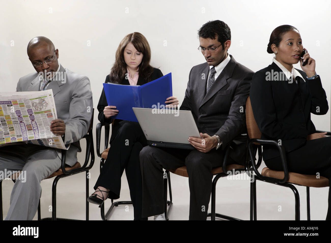Four people working in an office Stock Photo - Alamy