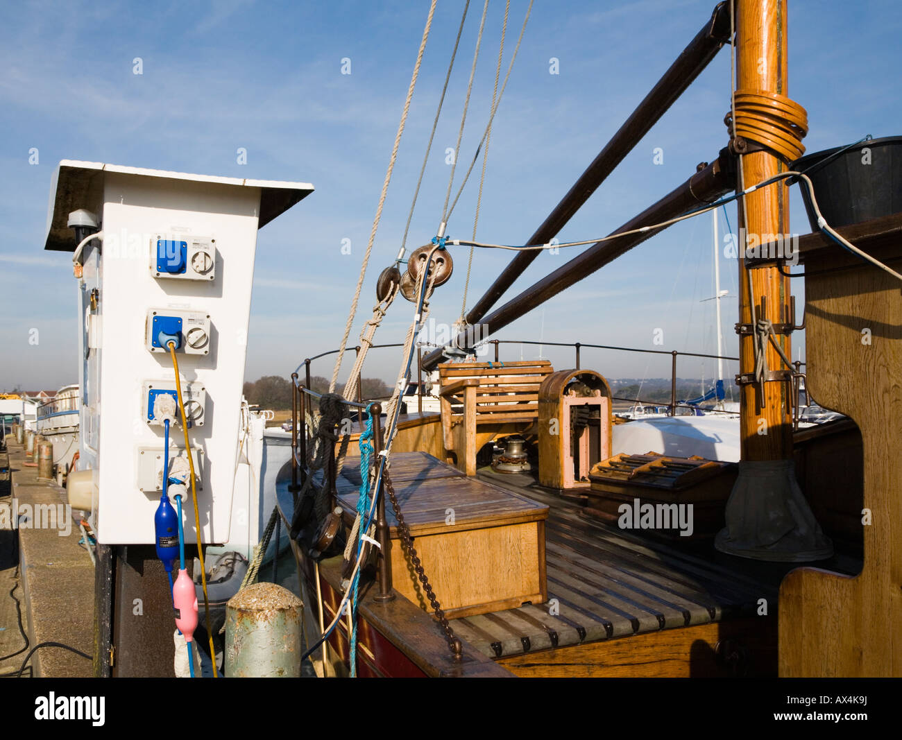 A traditional wooden boat, plugged in to a modern electricity supply ...