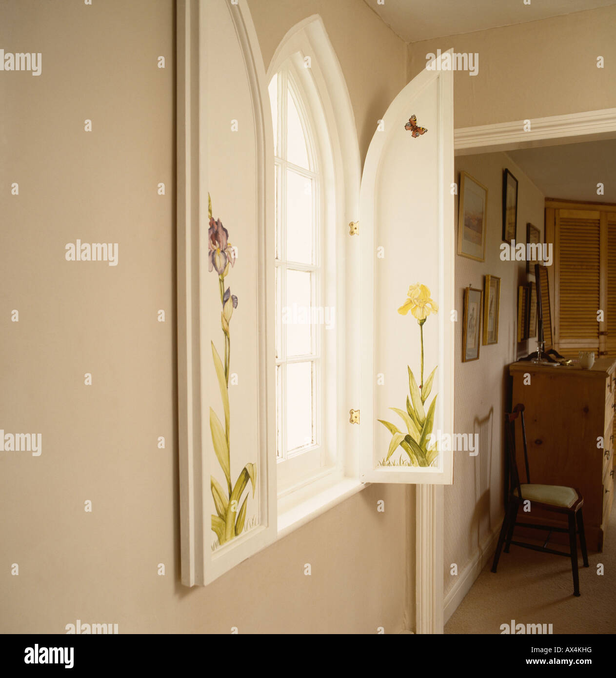 Paint effect irises on open Gothic shutters on landing window Stock ...
