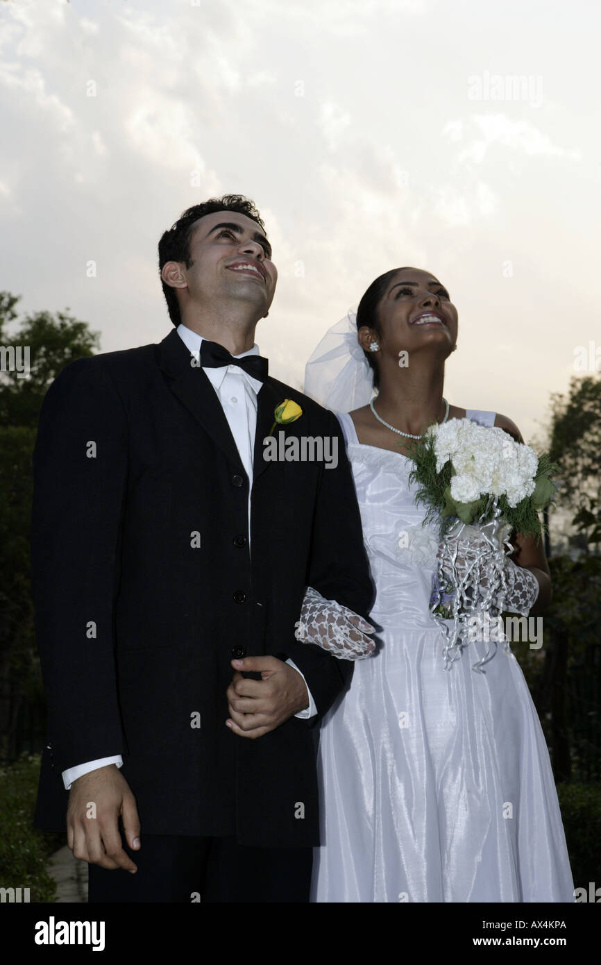 Low angle view of a married couple standing and smiling in a park Stock ...