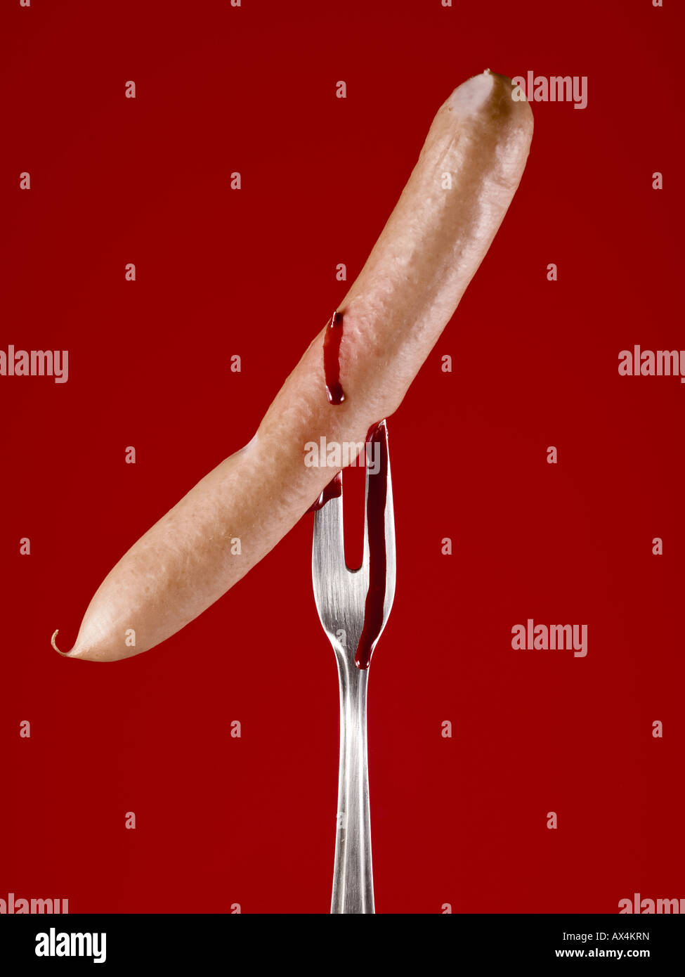 blood dripping from wiener sausage picked on meat fork, blood red ...