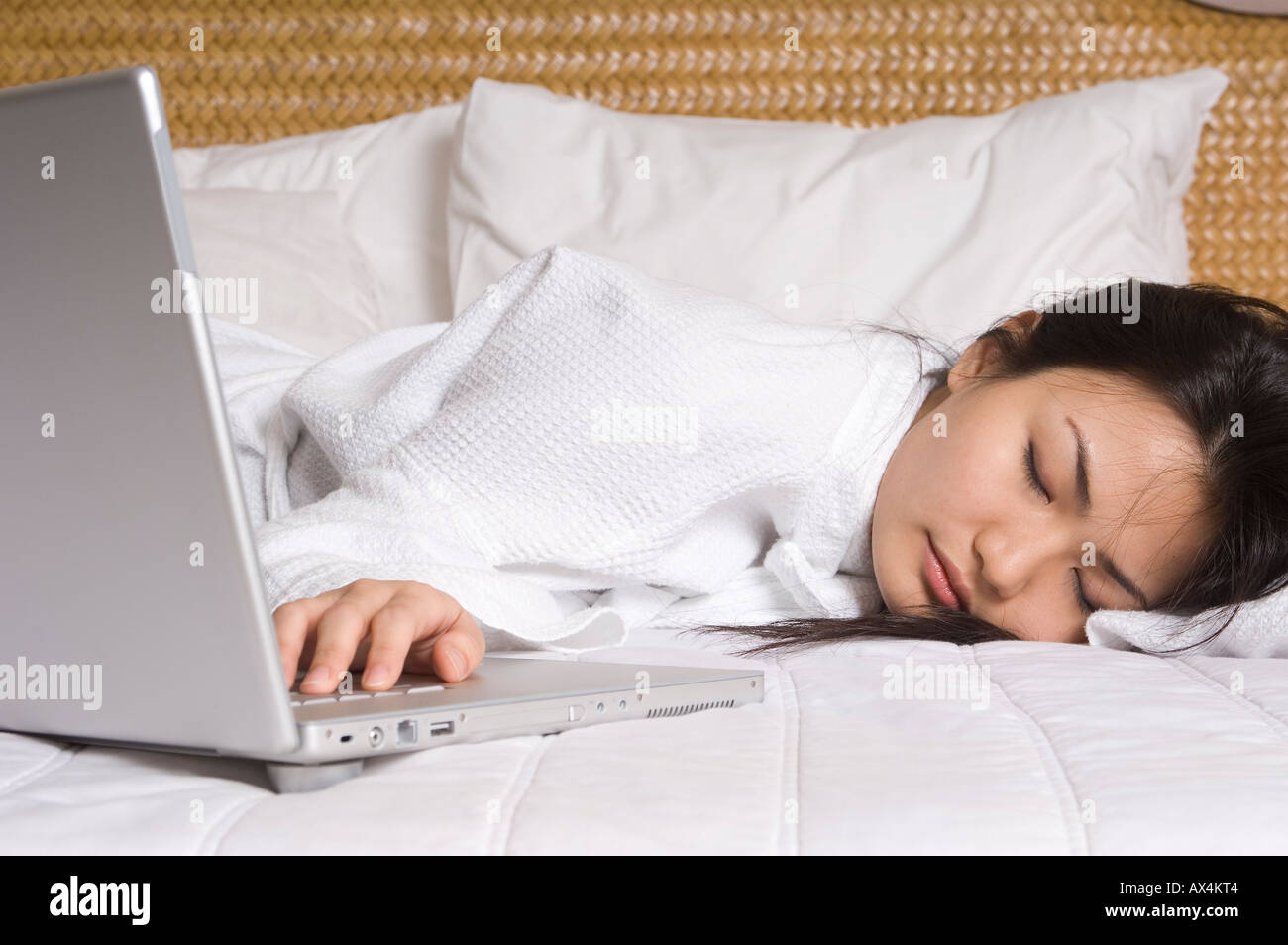 A young woman falls asleep next to her laptop computer Stock Photo - Alamy