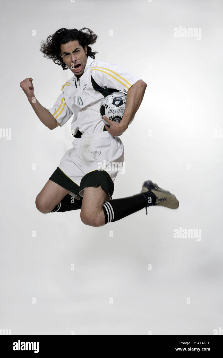 Portrait of a football player jumping Stock Photo - Alamy