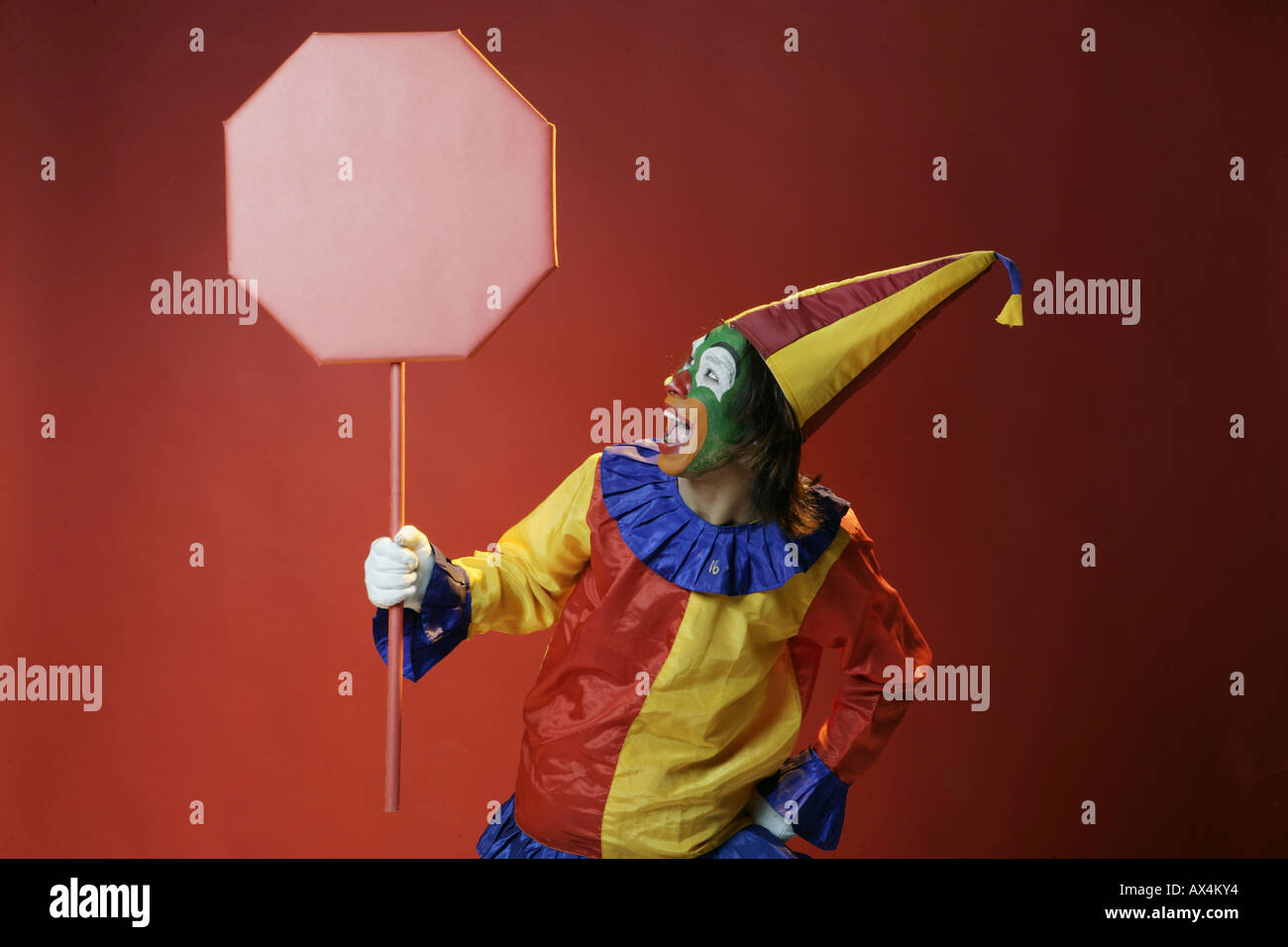 Joker holding a message board and laughing Stock Photo - Alamy