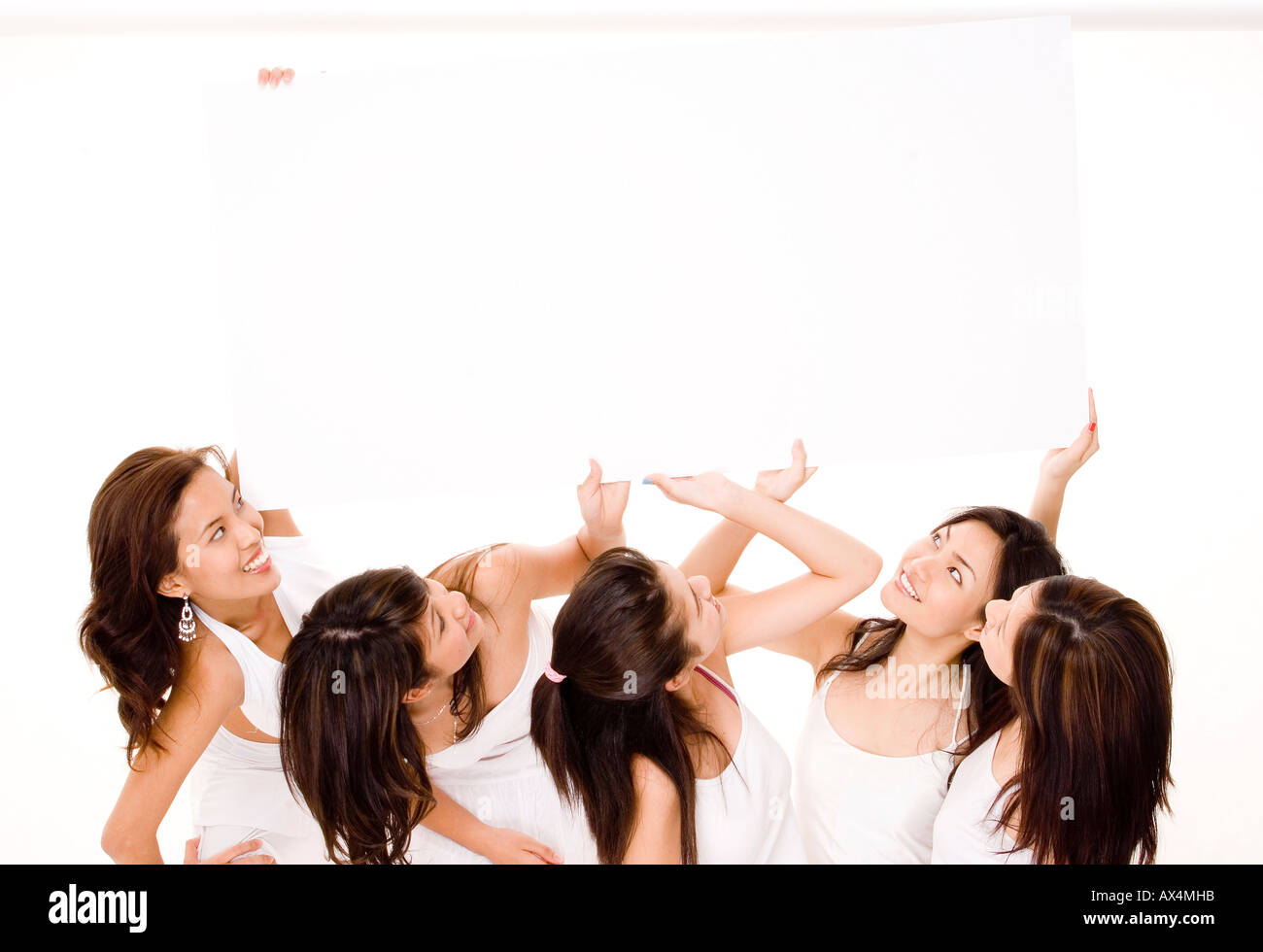 Five girls in white hold a large sign on white background Stock Photo ...