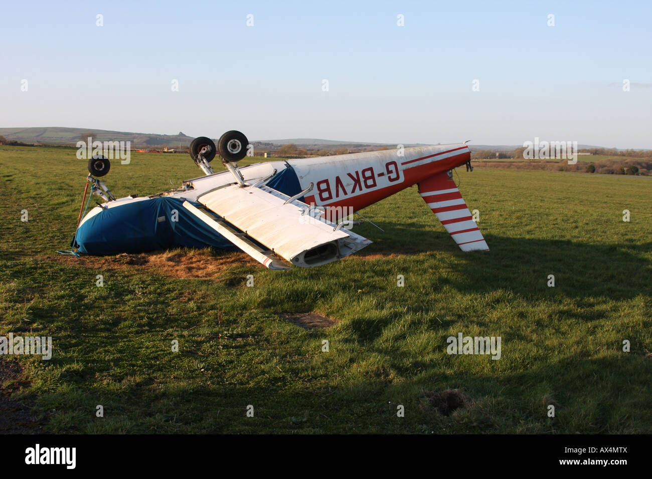 Small Airplane crash upside down on airfield, blown by gust of wind ...