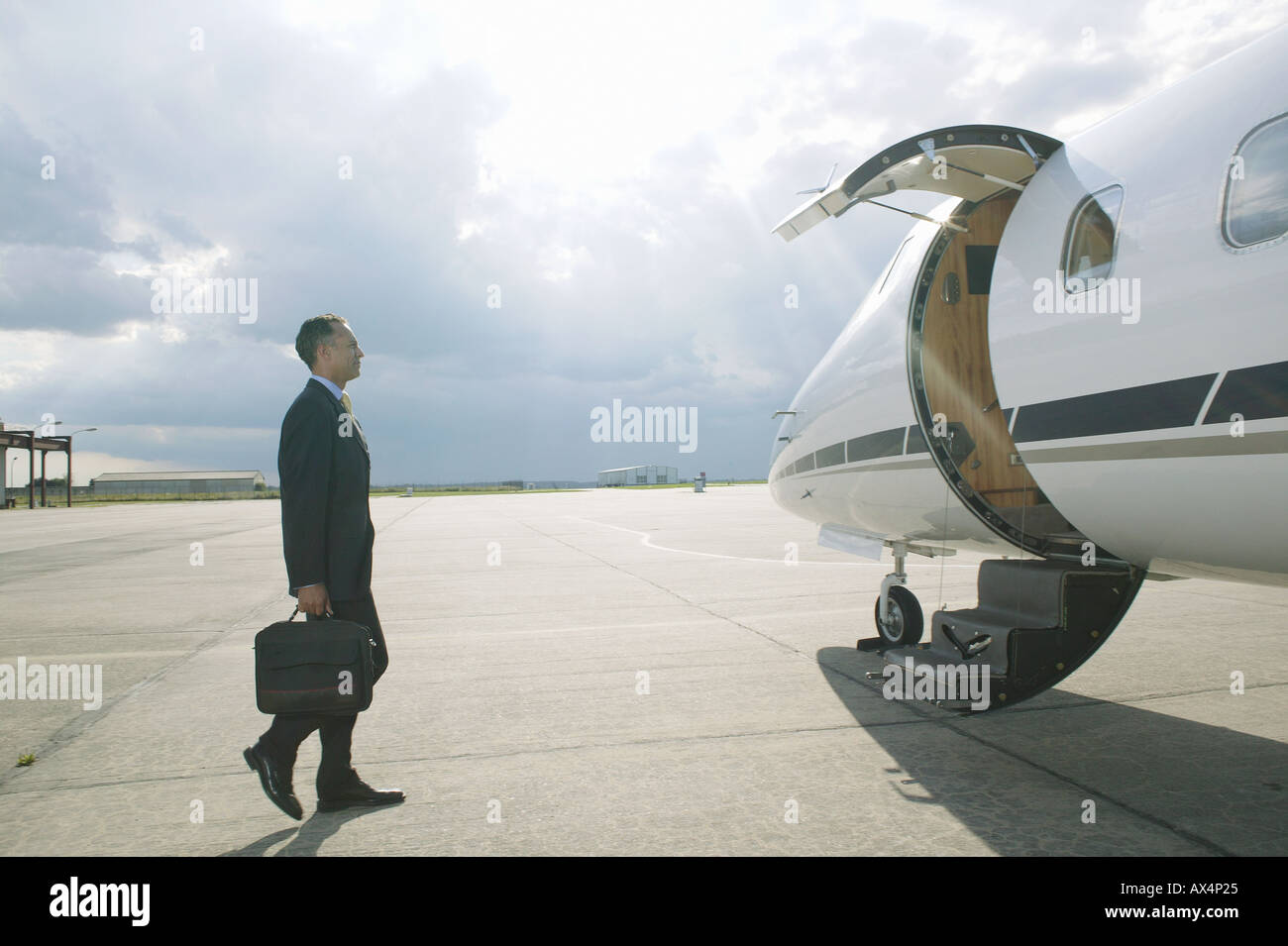 Businessman boarding a private airplane Stock Photo - Alamy