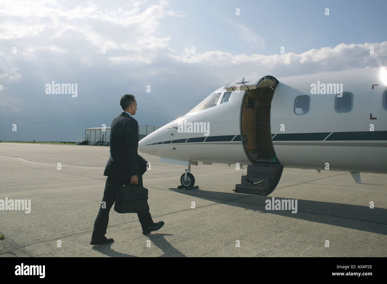 Businessman boarding a private airplane Stock Photo - Alamy