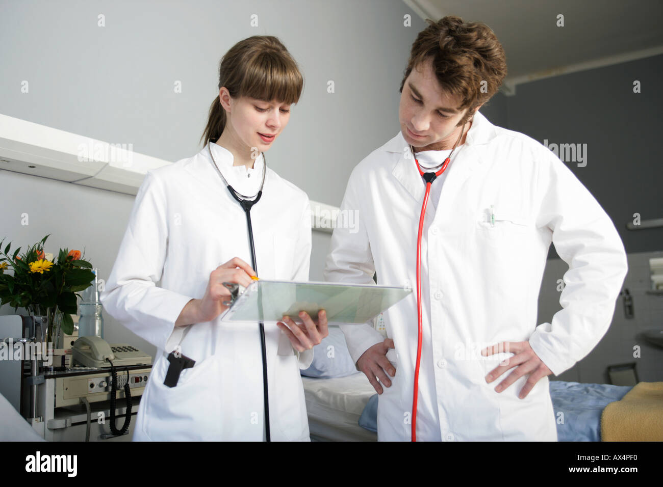Two doctors looking at a medical chart Stock Photo - Alamy