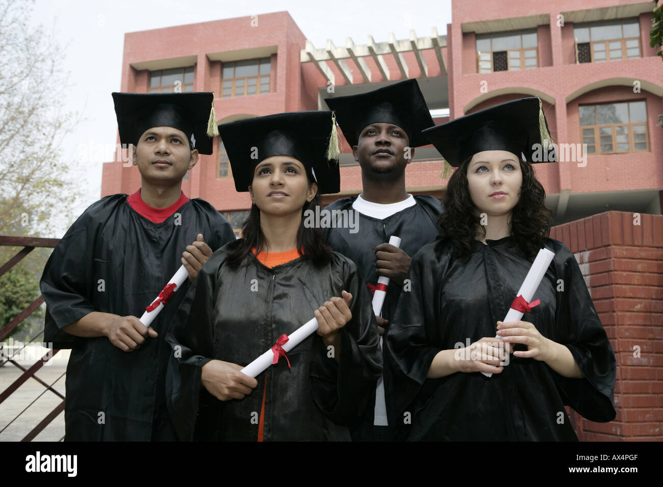 Students standing in front of their college in convocation gown Stock ...