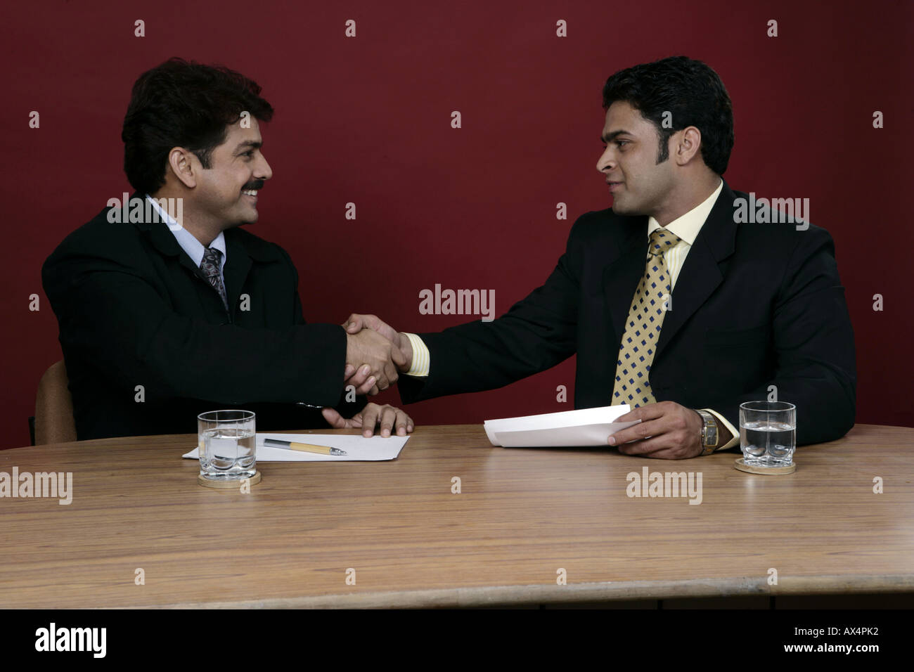 Two businessmen shaking hands Stock Photo - Alamy