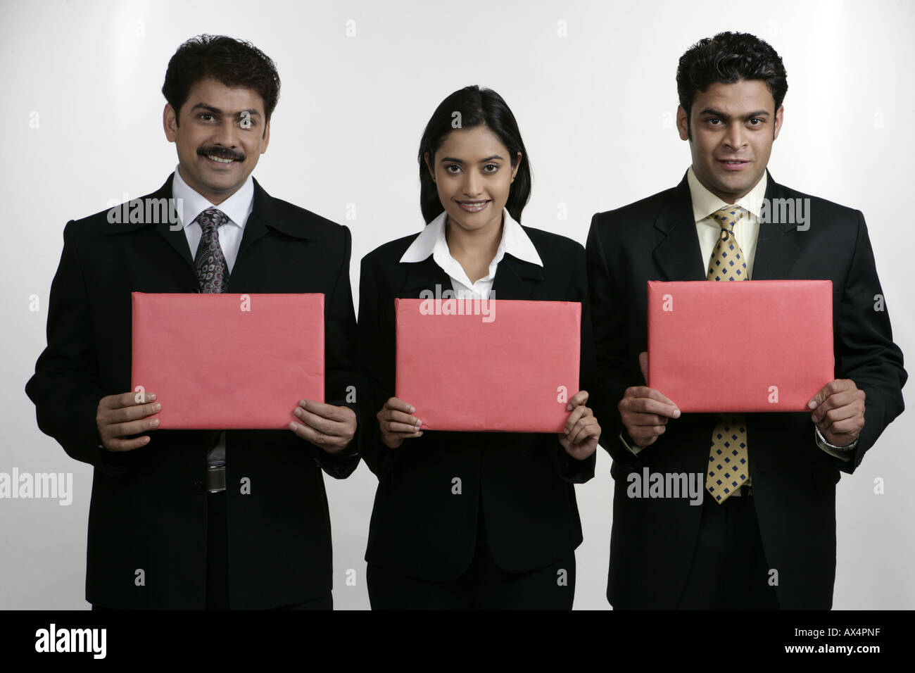 Portrait of three business people holding placards Stock Photo - Alamy