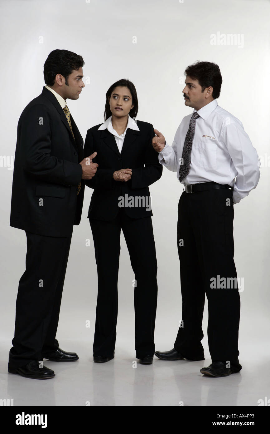 Three business people discussing Stock Photo - Alamy