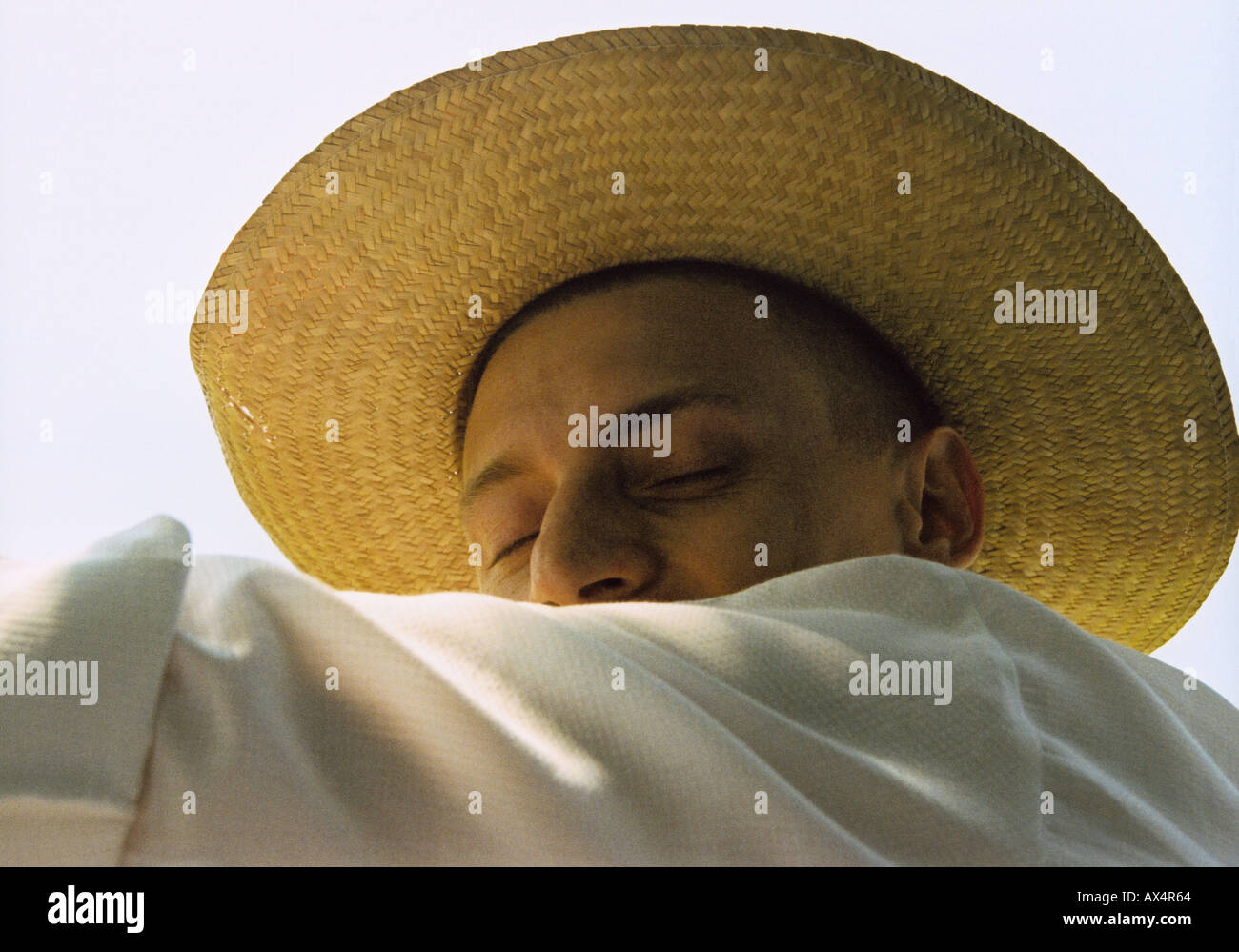 Man wearing a straw hat Stock Photo - Alamy