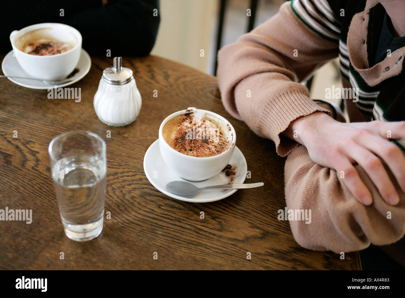 Close up of two people sitting in a cafe Stock Photo - Alamy