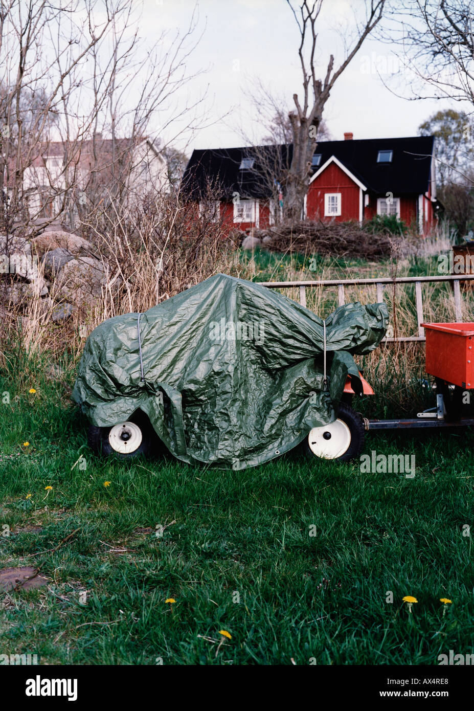 Tractor with plastic rain cover Stock Photo - Alamy