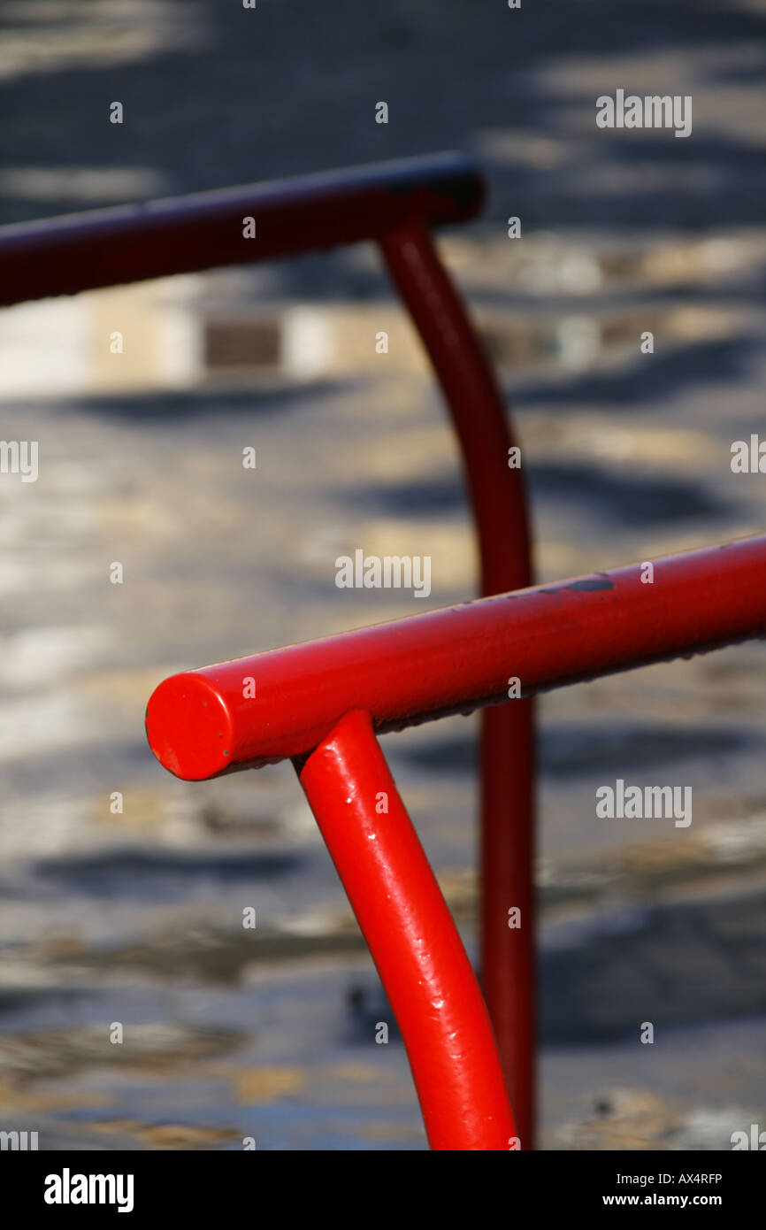 red metal hand rail in play area in park Stock Photo - Alamy