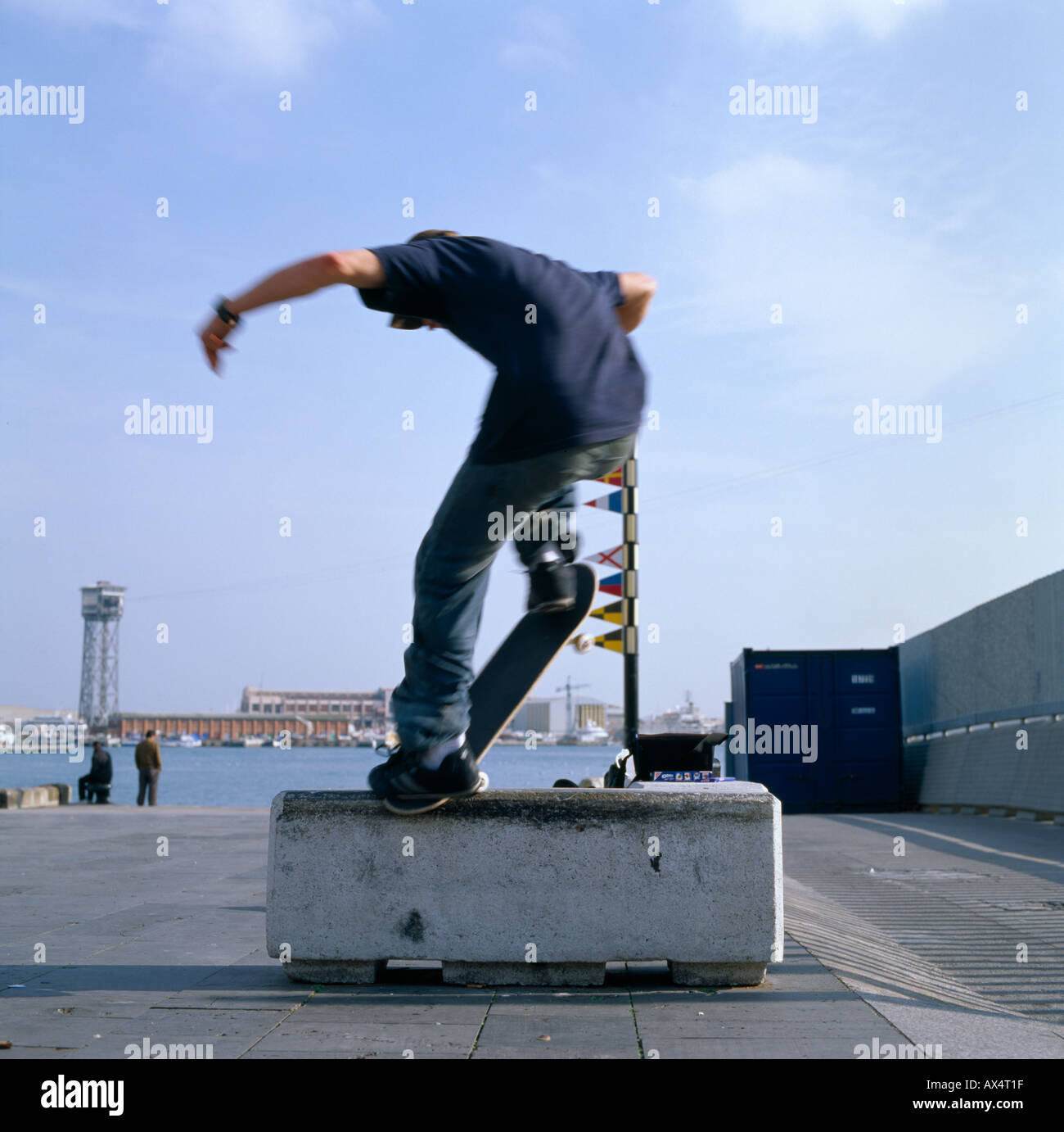 Man on skateboard balancing on stone block Stock Photo - Alamy