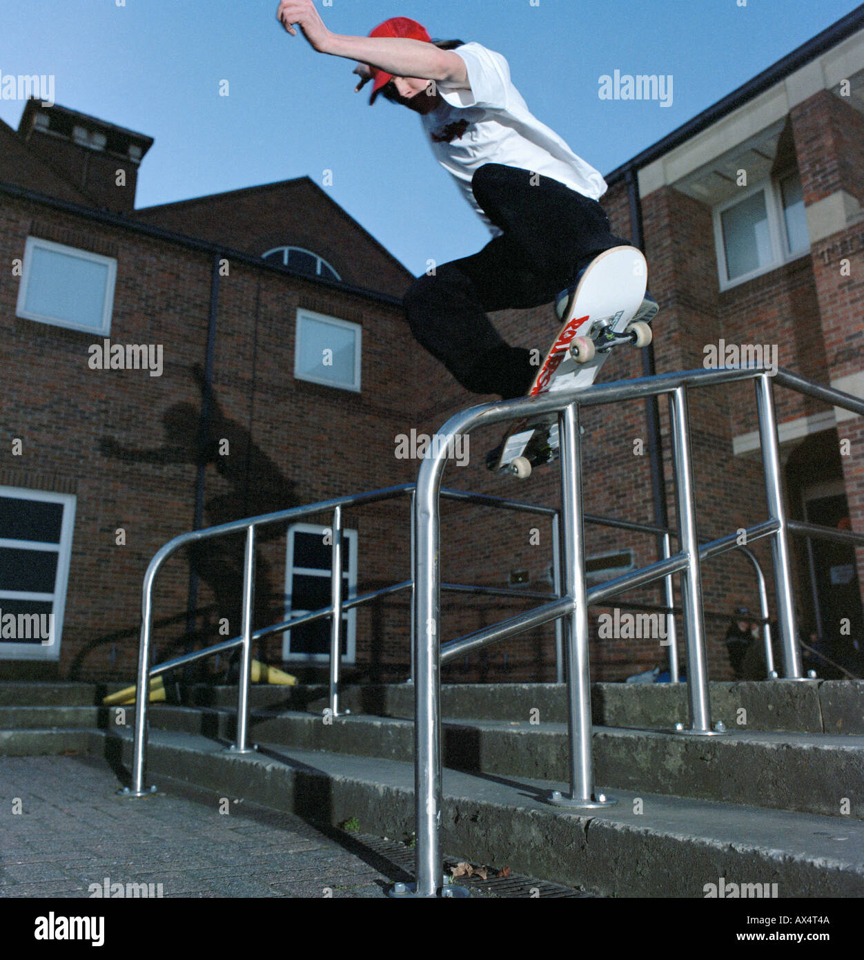 Man on skateboard balancing on railing Stock Photo - Alamy