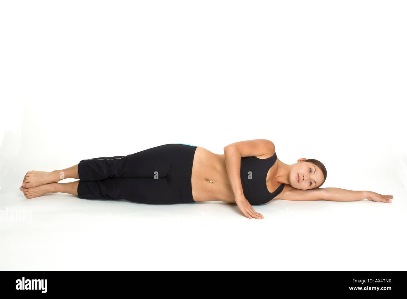 A female fitness instructor demonstrates the starting position of the ...