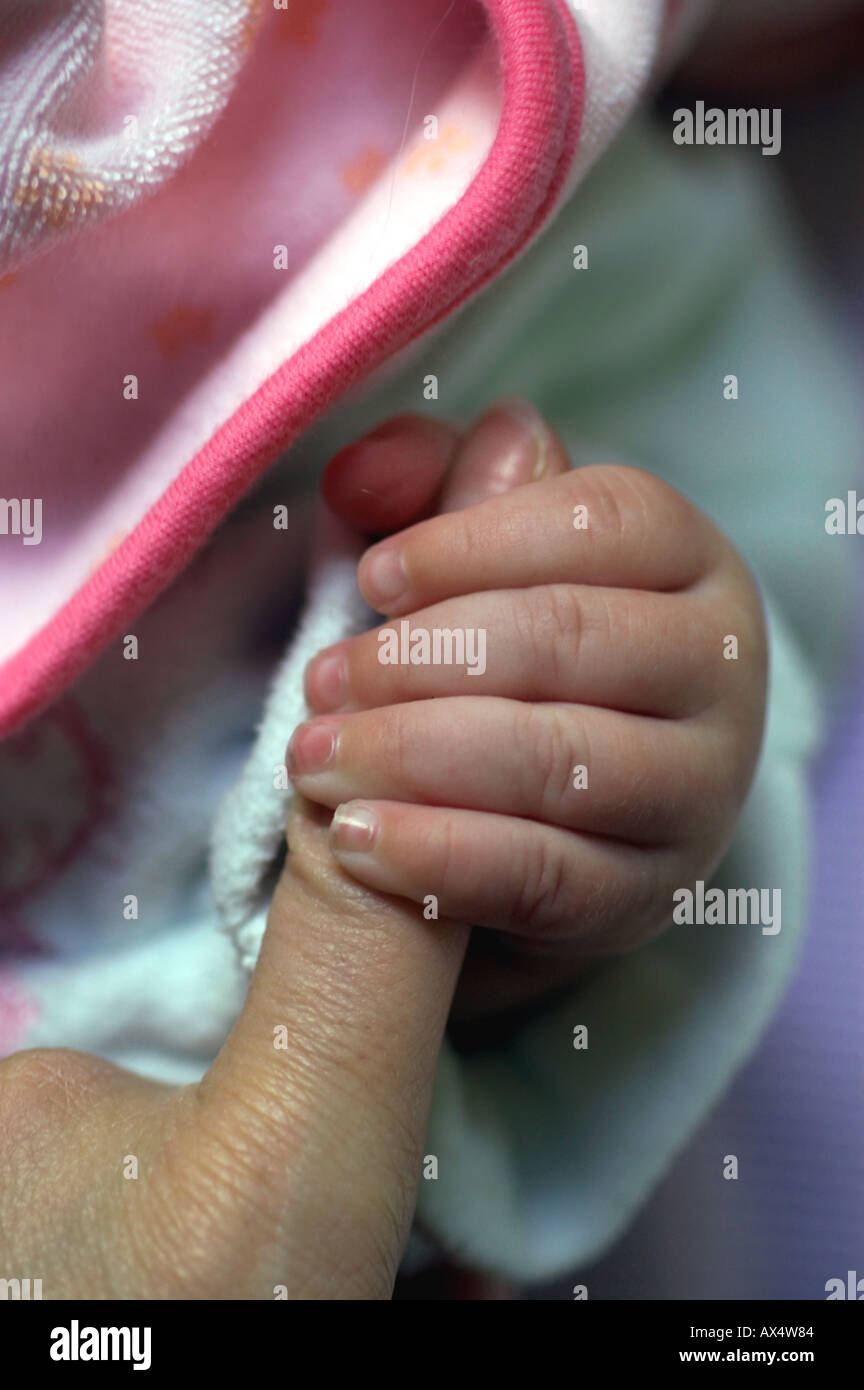 baby hand holding onto mother s finger Stock Photo - Alamy