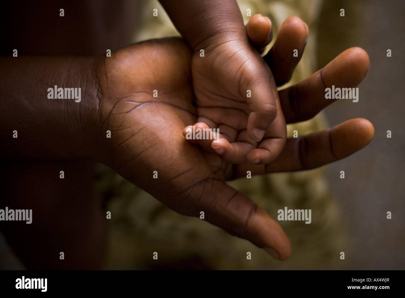Small hand of a child in the larger hand of an adult Stock Photo - Alamy