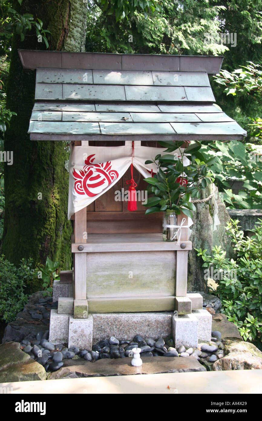 Small wooden shinto shrine next to a mountain path in Japan Stock Photo ...